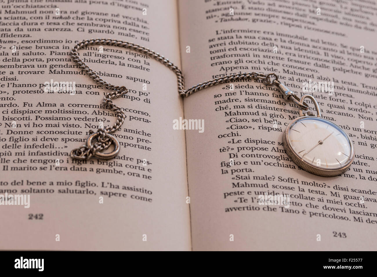 clock on a book Stock Photo - Alamy