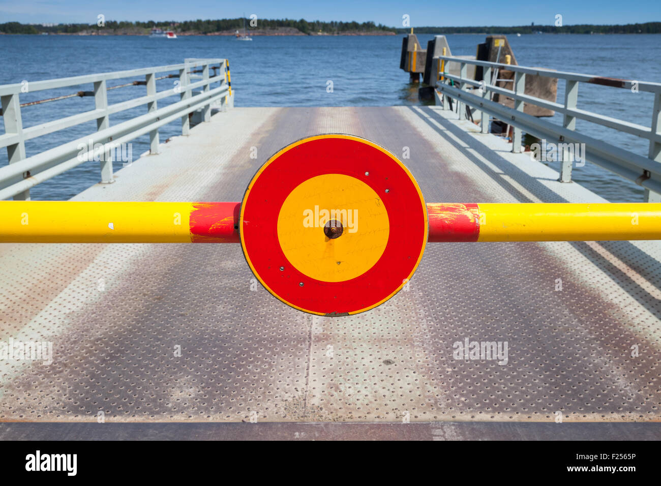 Red and yellow stop sign on closed turnpike to empty ferry terminal ...