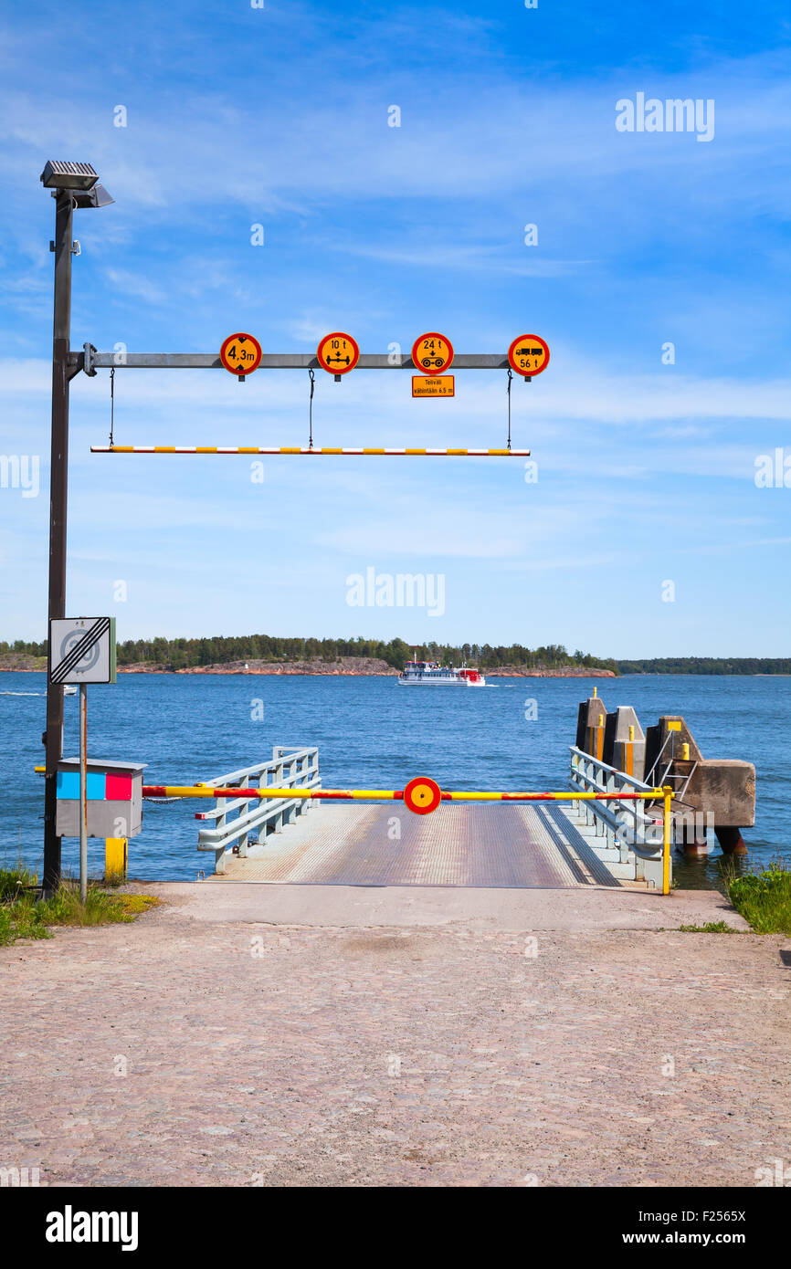 Small empty ferry terminal with metal ramp, cosed turnpike and ...