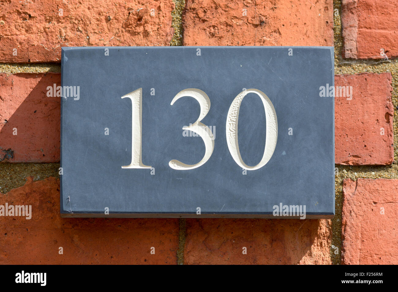 House number 130 sign on wall outside Stock Photo - Alamy