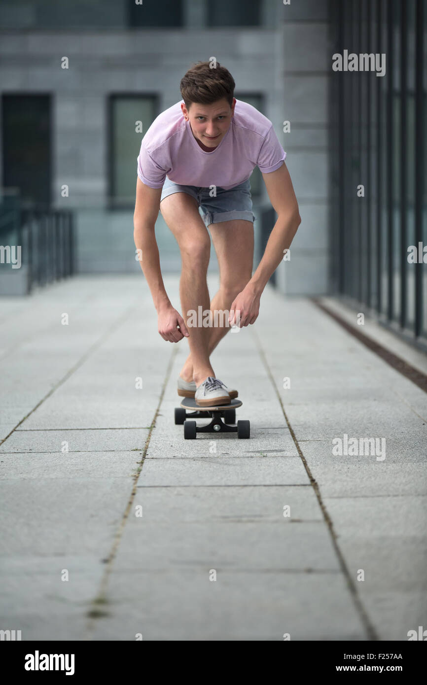 Stylish teenager riding a longboard Stock Photo - Alamy