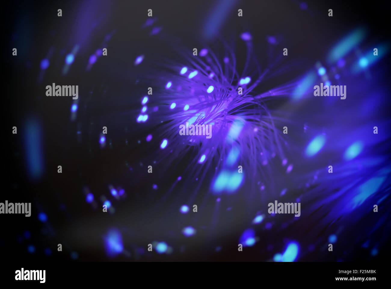 violet colored particles fly in space of the optical fiber and circling ...