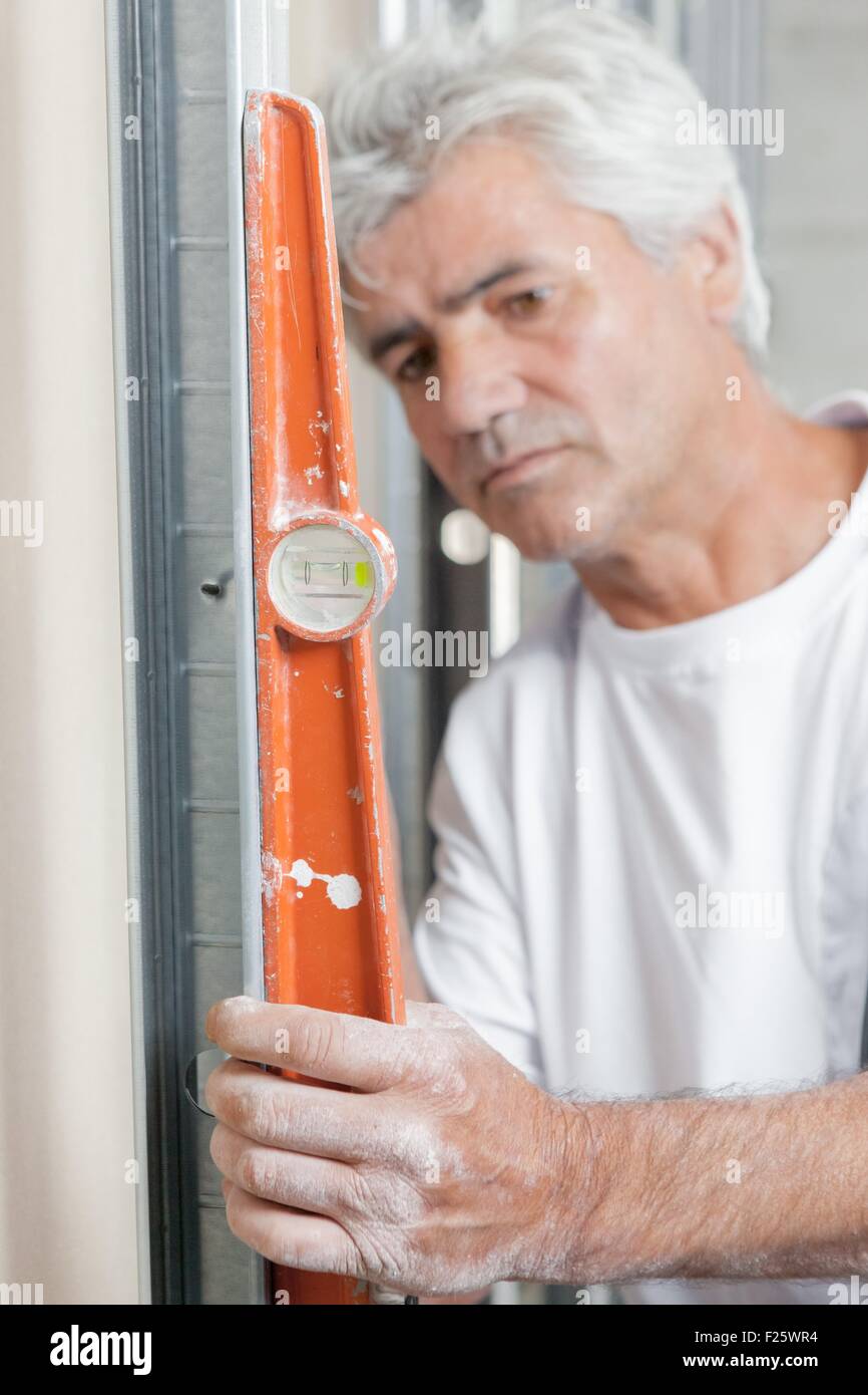 Mason measuring a wall Stock Photo - Alamy