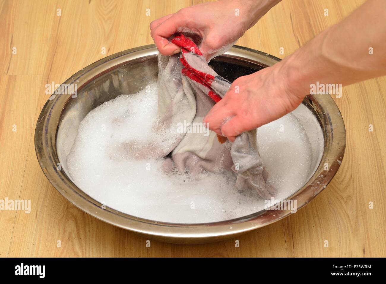 wash sweaters in metal basin with foam and soap Stock Photo - Alamy