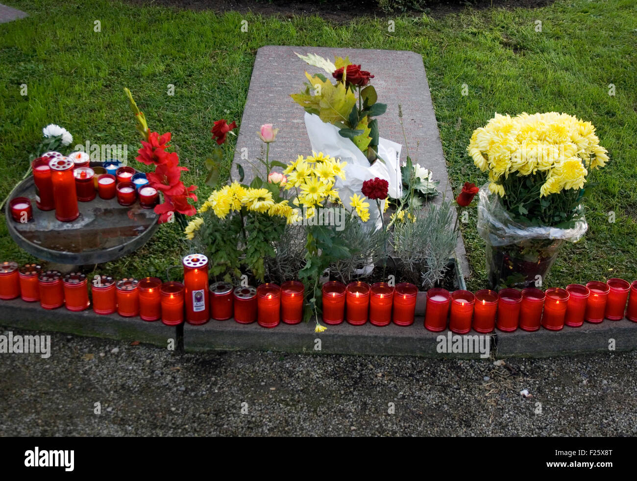 Flower and funeral candles, All saint in Milan - Italy Stock Photo - Alamy