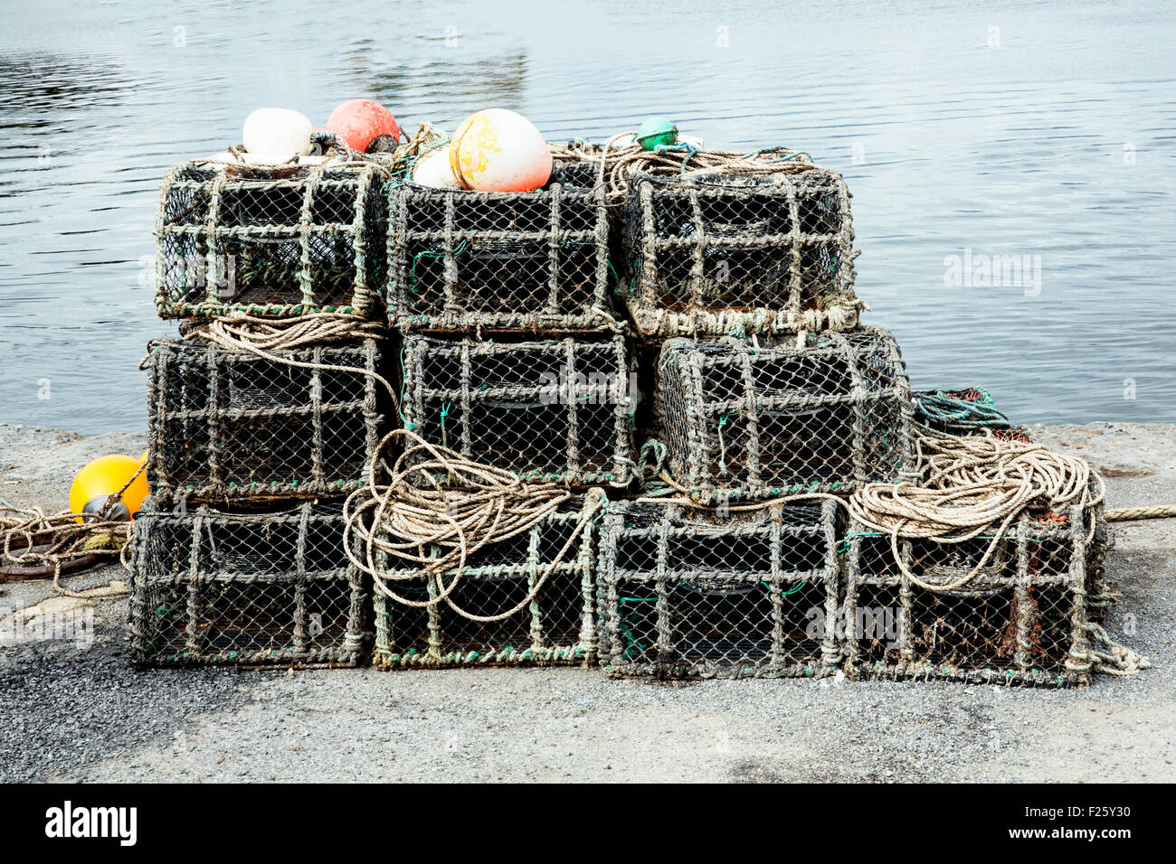Lobster pots on the harbour edge at Roundstone, Connemara Stock Photo ...