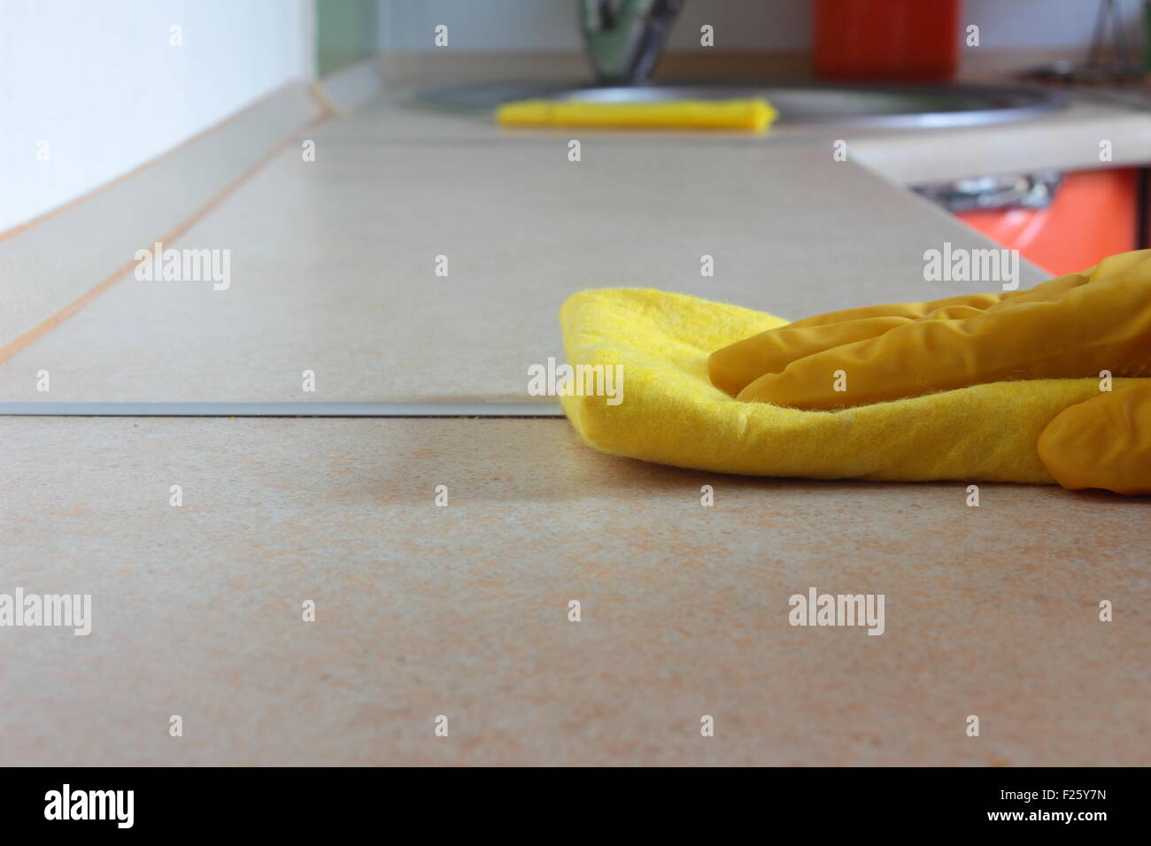 wipe the furniture with a damp cloth in rubber gloves Stock Photo - Alamy