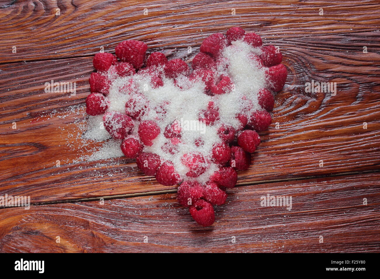 Heart laid out from a raspberry sugar Stock Photo - Alamy
