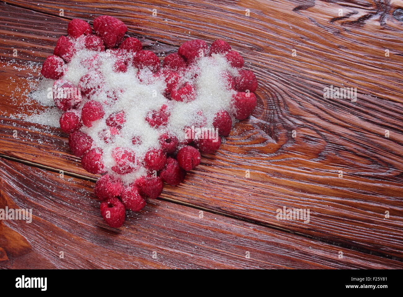 Heart laid out from a raspberry sugar Stock Photo - Alamy