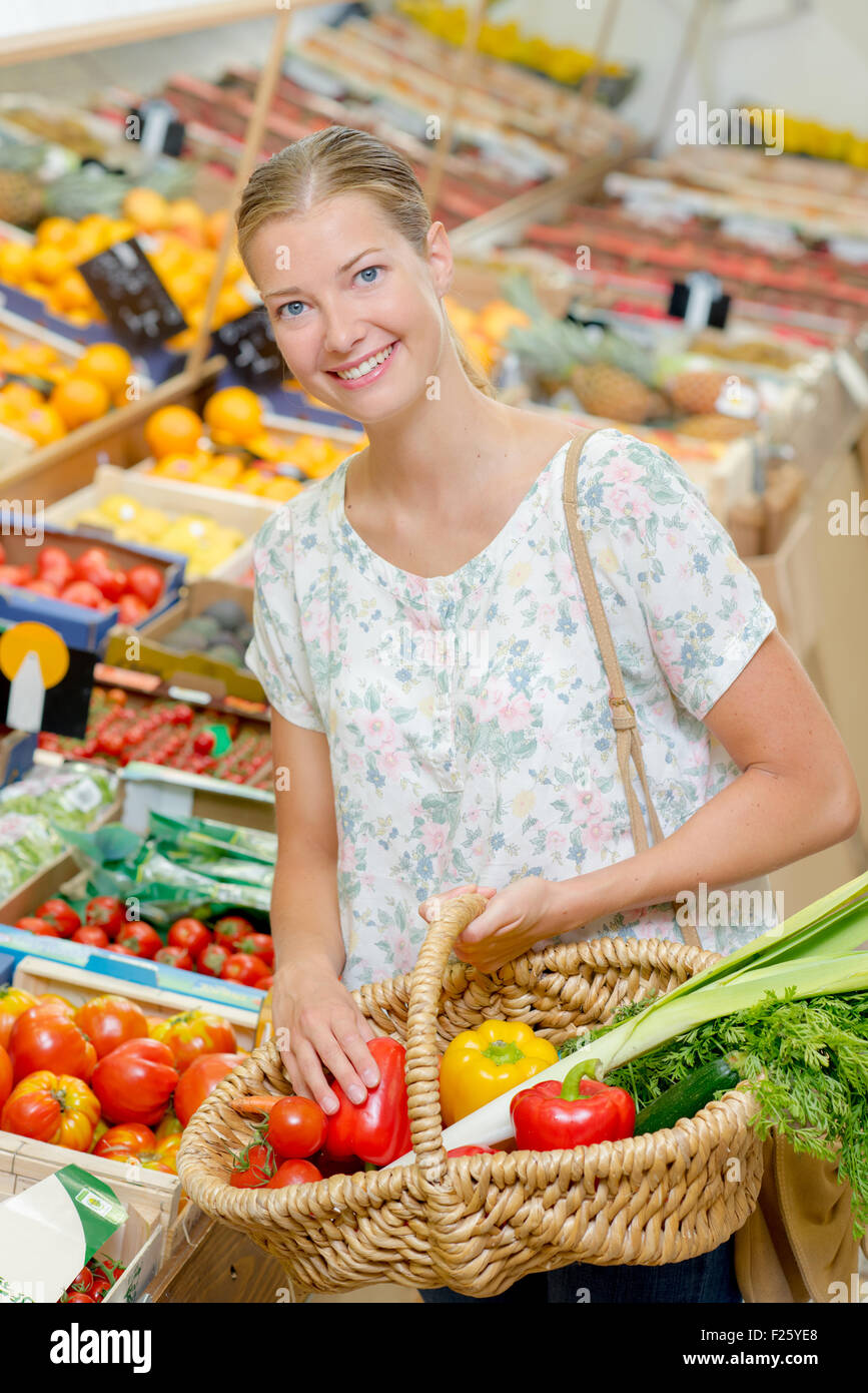 Filling her basket up with vegetables Stock Photo - Alamy