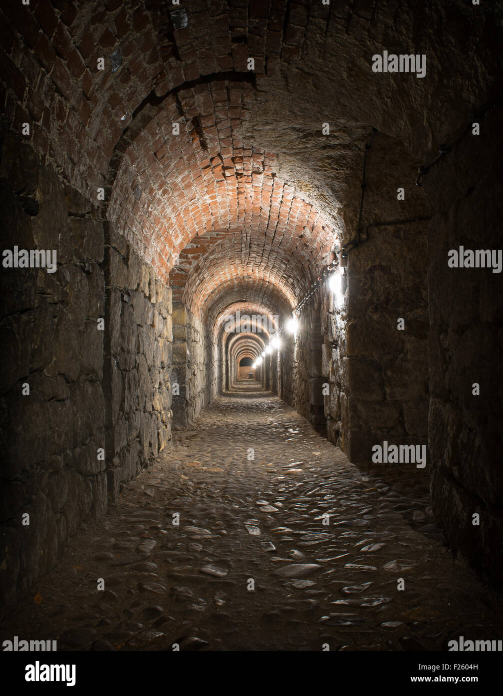 Old medieval brick tunnel with light at the end Stock Photo - Alamy