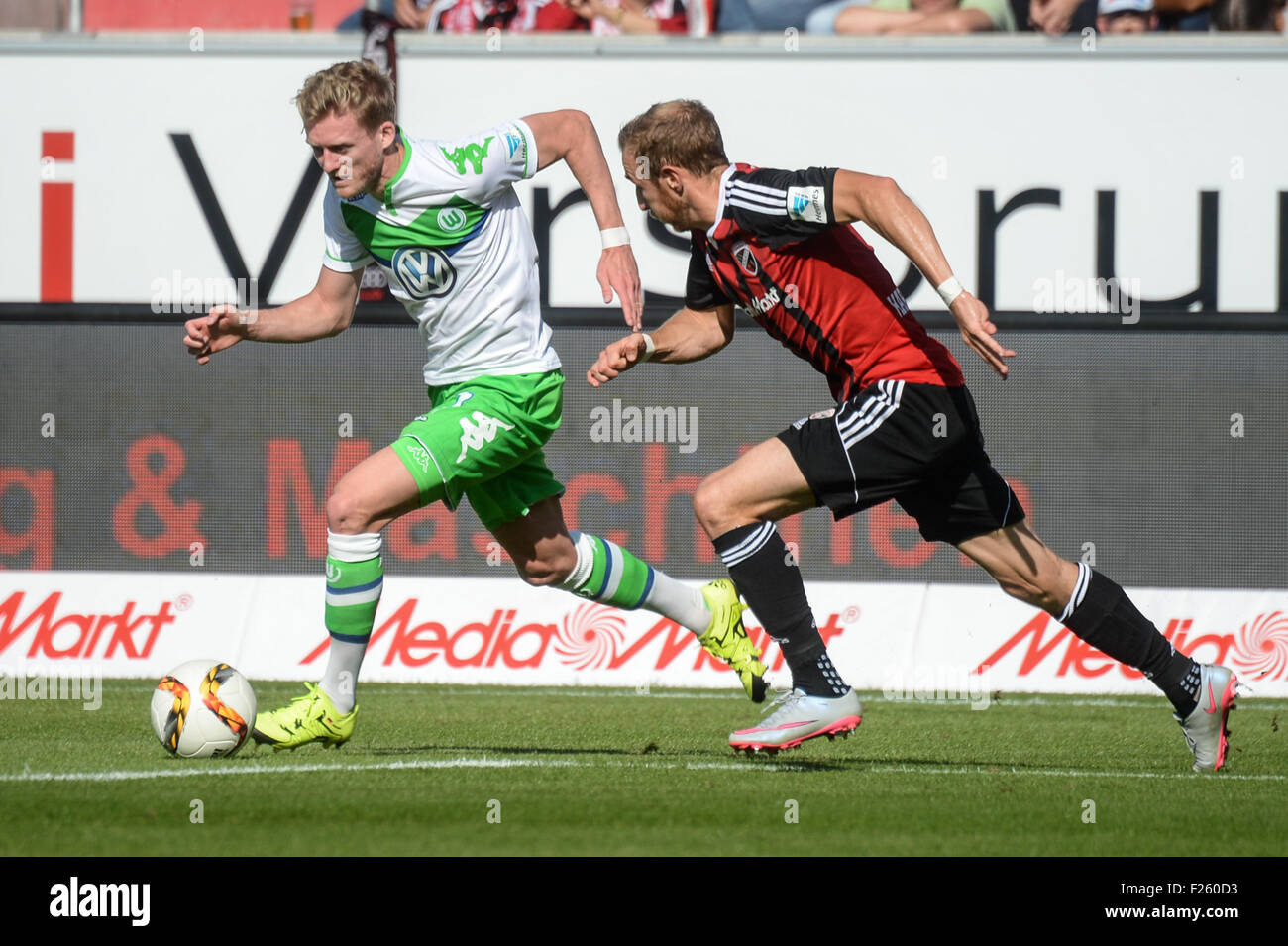 Ingolstadt, Germany. 12th Sep, 2015. Ingolstadt'S Moritz Hartmann (r) and Wolfsburg'S Andre ...