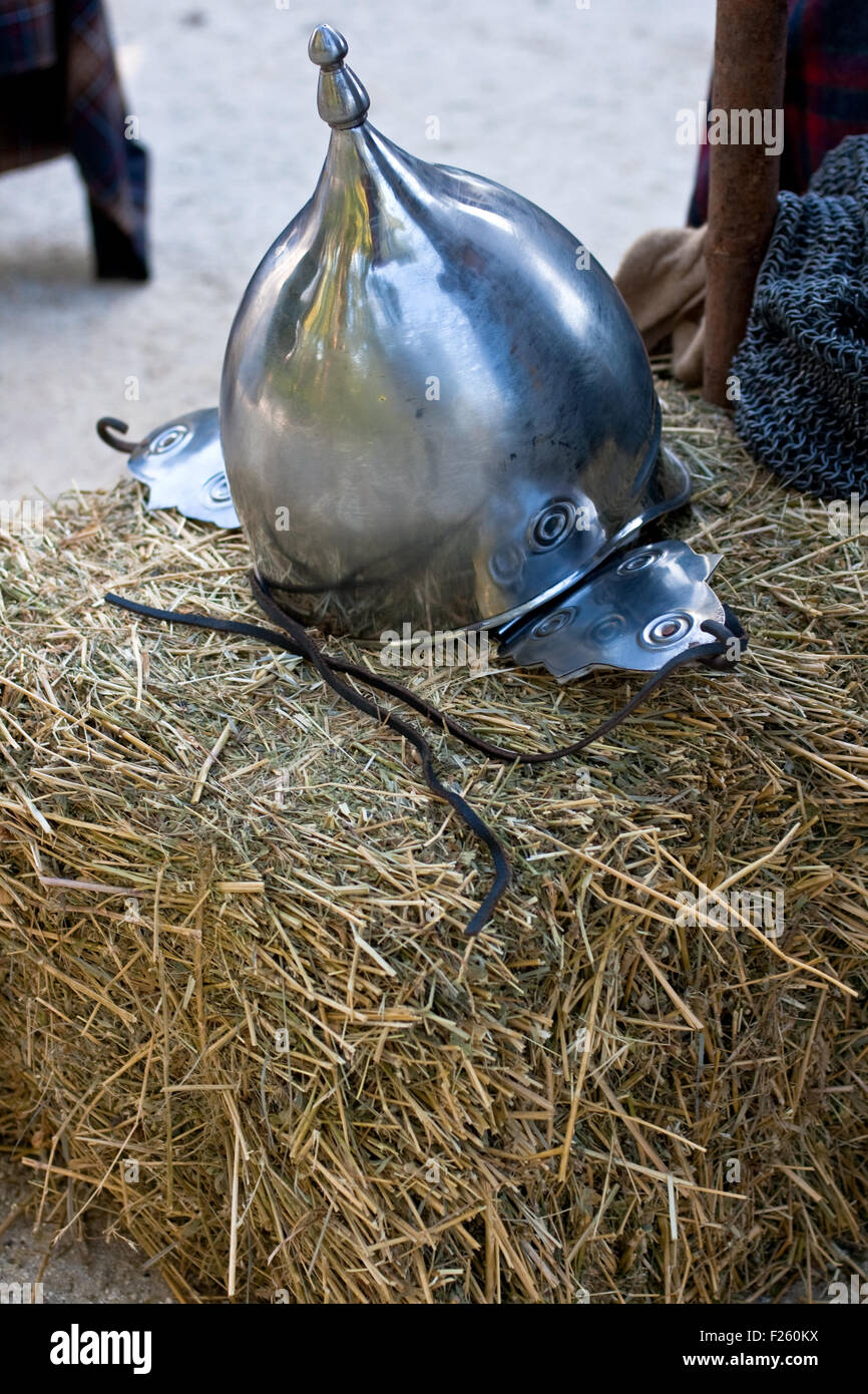 Helmet on a bales of hay Stock Photo - Alamy
