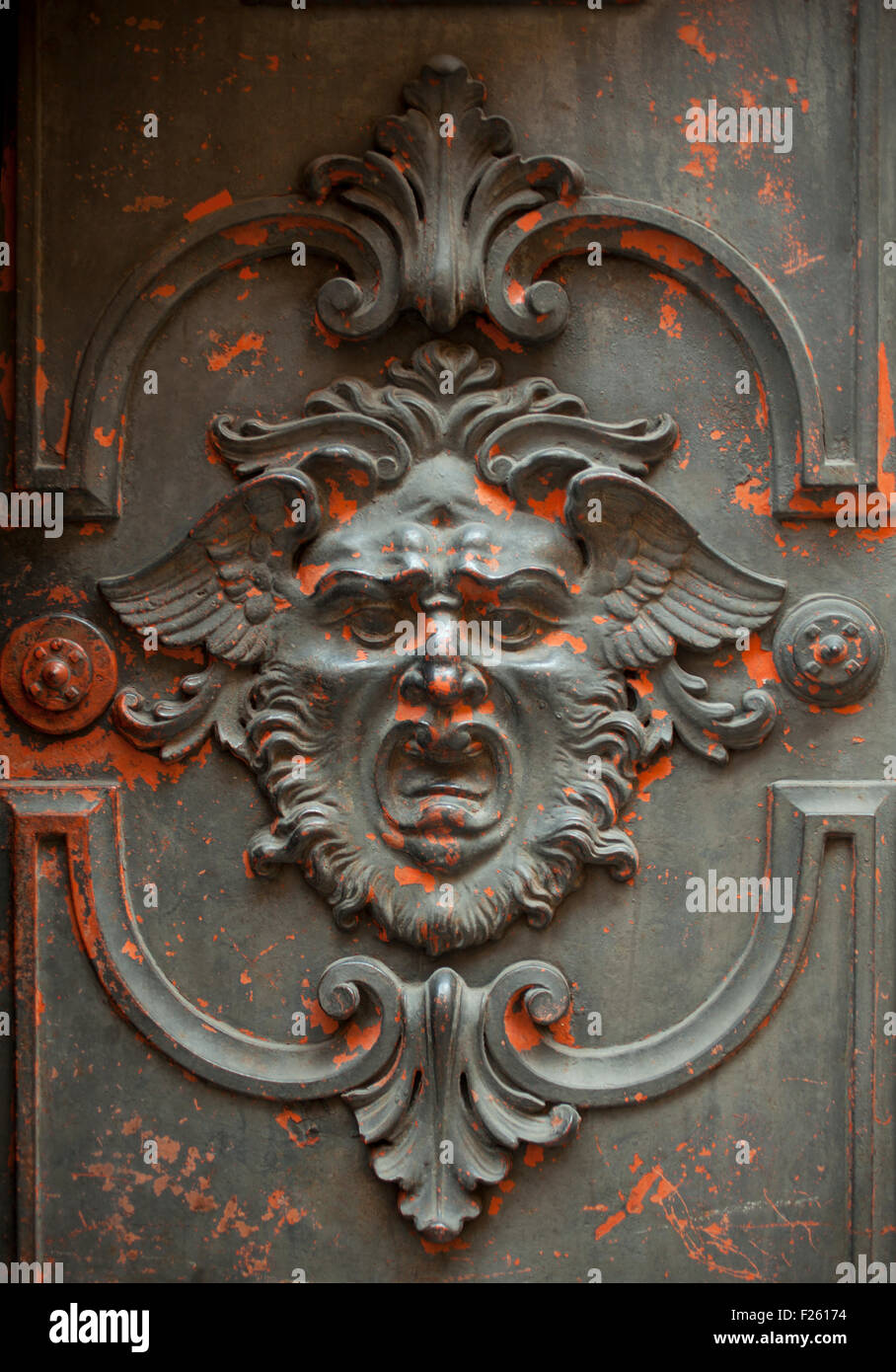 Monstrous face carved into a wooden door Stock Photo - Alamy
