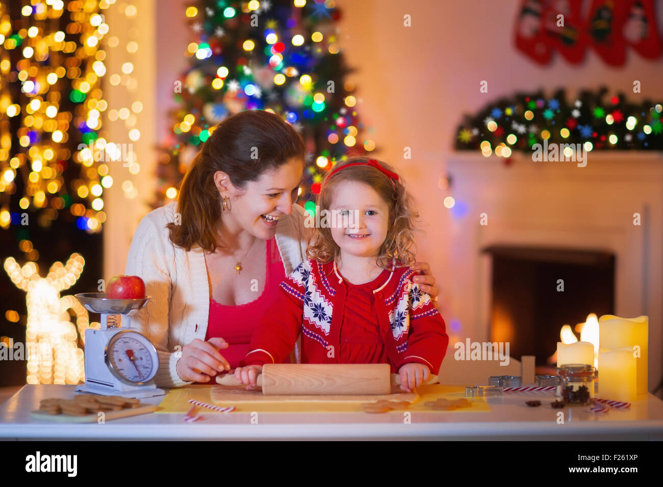 Mother and little girl baking Christmas pastry. Children bake ...
