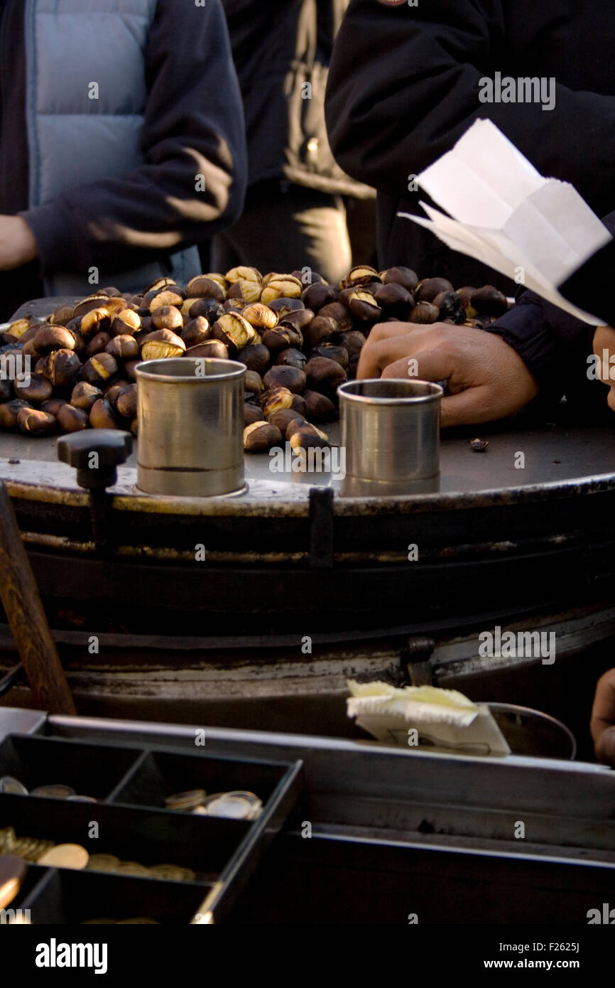 Freshly roasted chestnuts inside a iron plate Stock Photo - Alamy