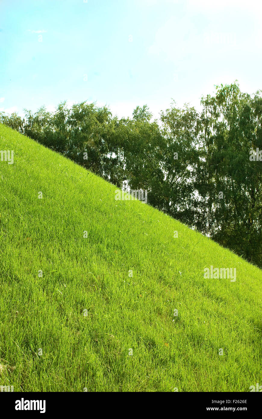 green grass on a hill steep gradient Stock Photo - Alamy