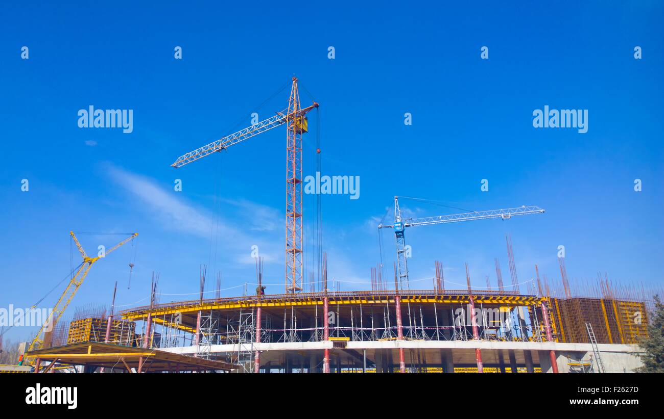 building crane over sky builds stadium Stock Photo - Alamy