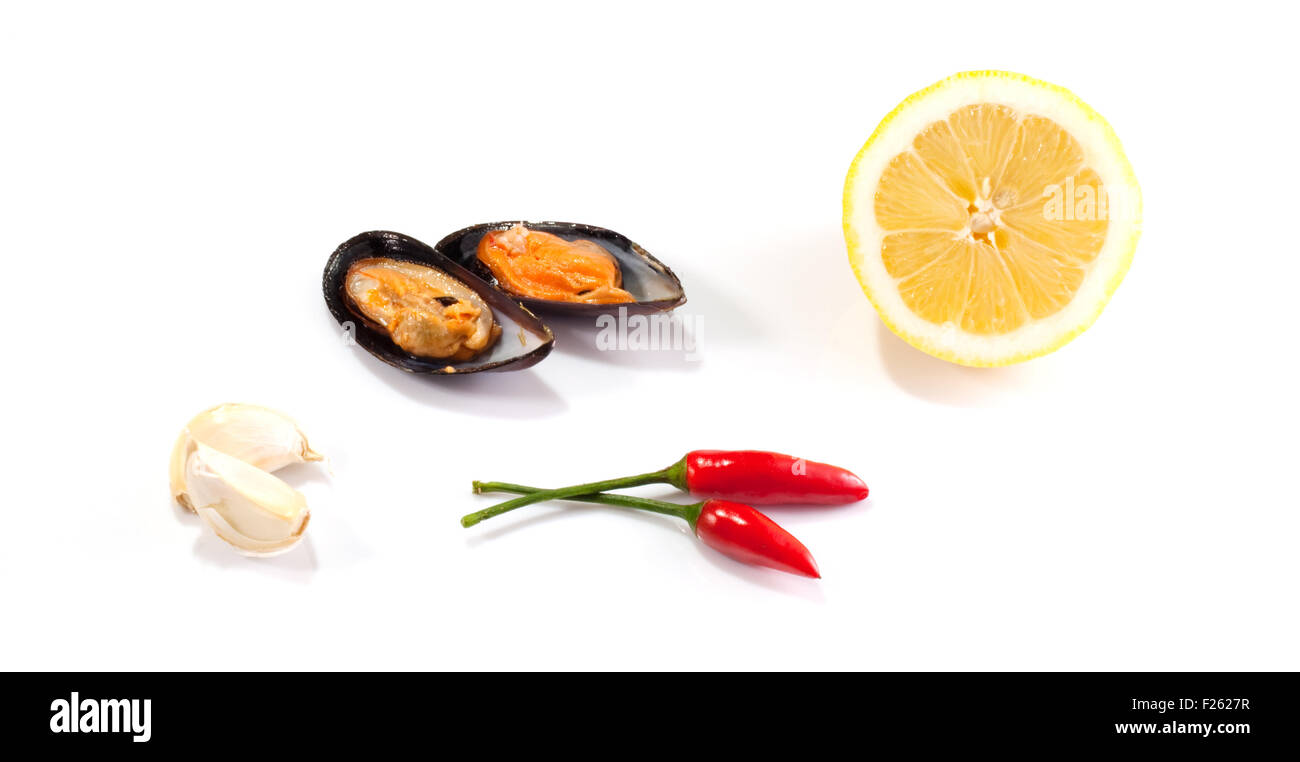 Mussels, lemon and chilli on a white background Stock Photo - Alamy