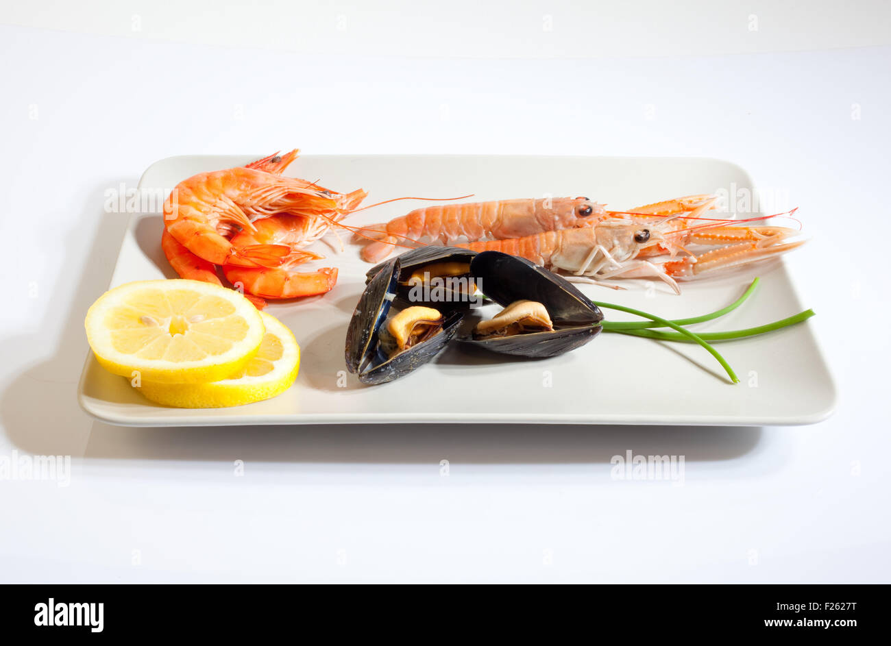 Crustacean and mussels on dish on white background Stock Photo - Alamy