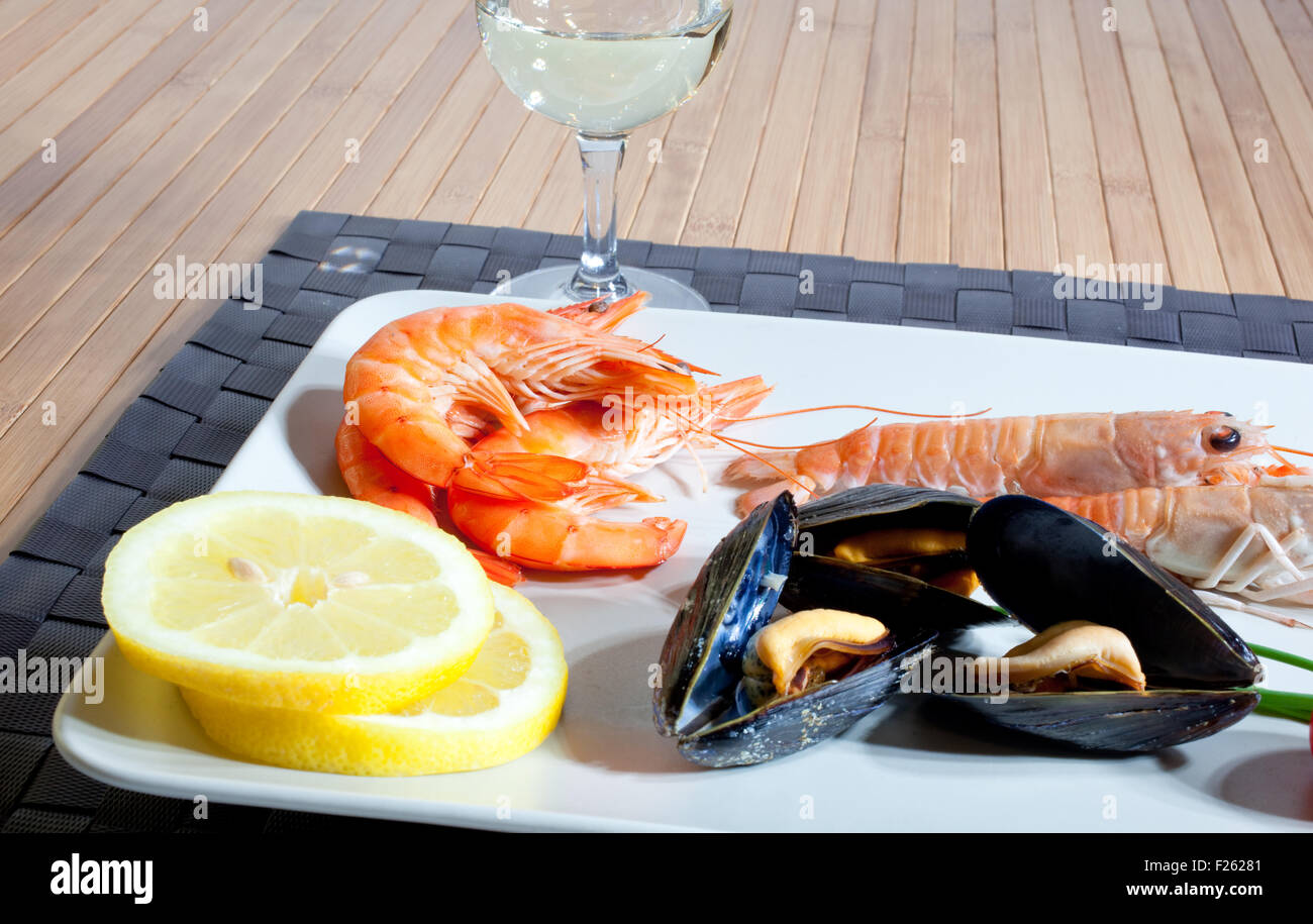 Mussels lemon and crustacean on dish Stock Photo - Alamy