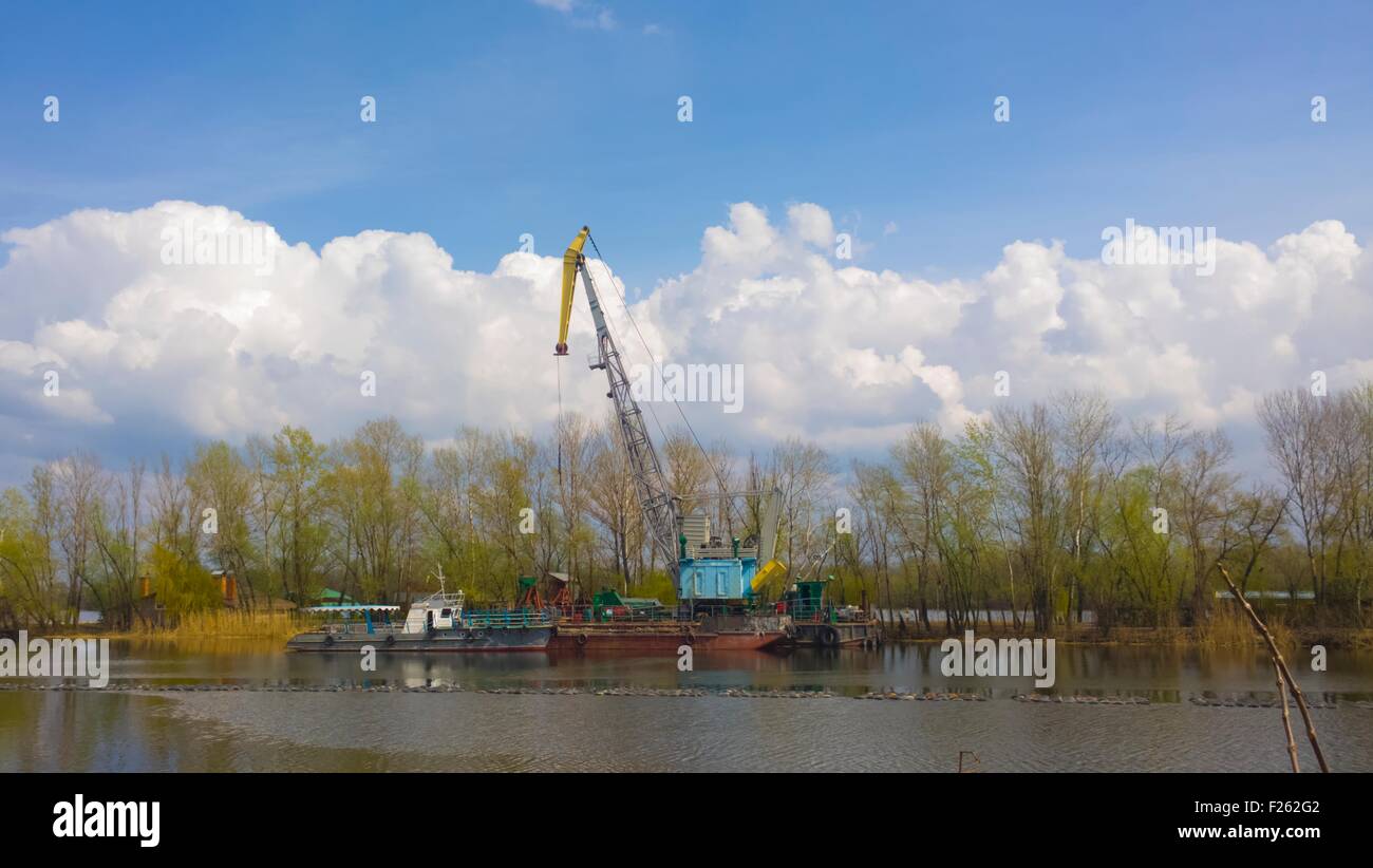 crane on river loading cargo Stock Photo - Alamy