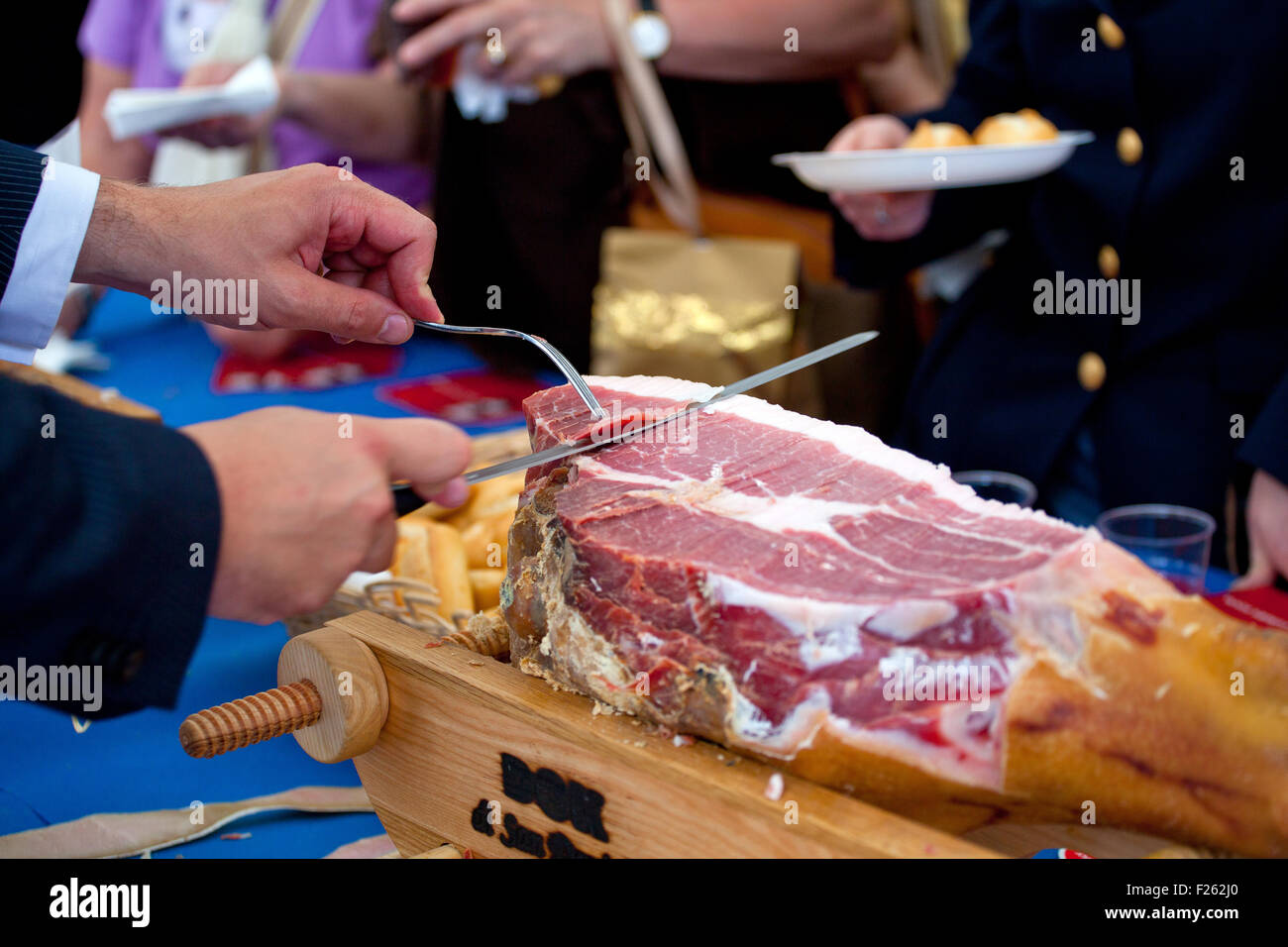 Waiter is slicing Italian raw ham Stock Photo - Alamy