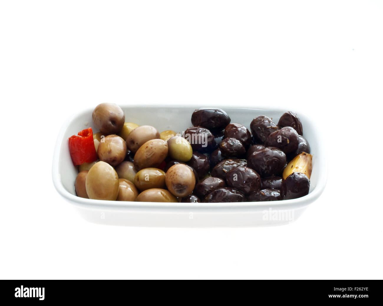Olives inside a saucer on white background Stock Photo - Alamy