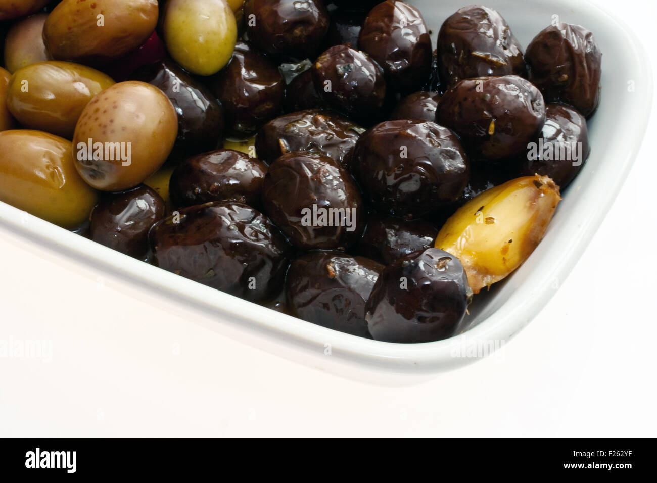 Olives inside a saucer on white background Stock Photo - Alamy