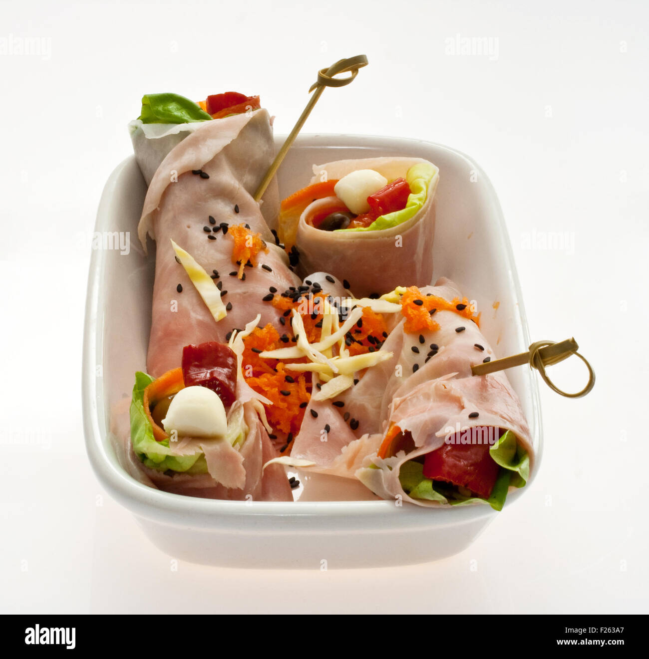 Appetizer with ham inside a saucer on a white background Stock Photo ...