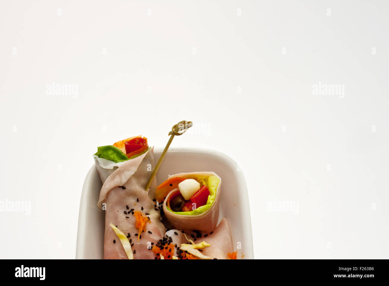 Appetizer with ham inside a saucer on a white background Stock Photo ...