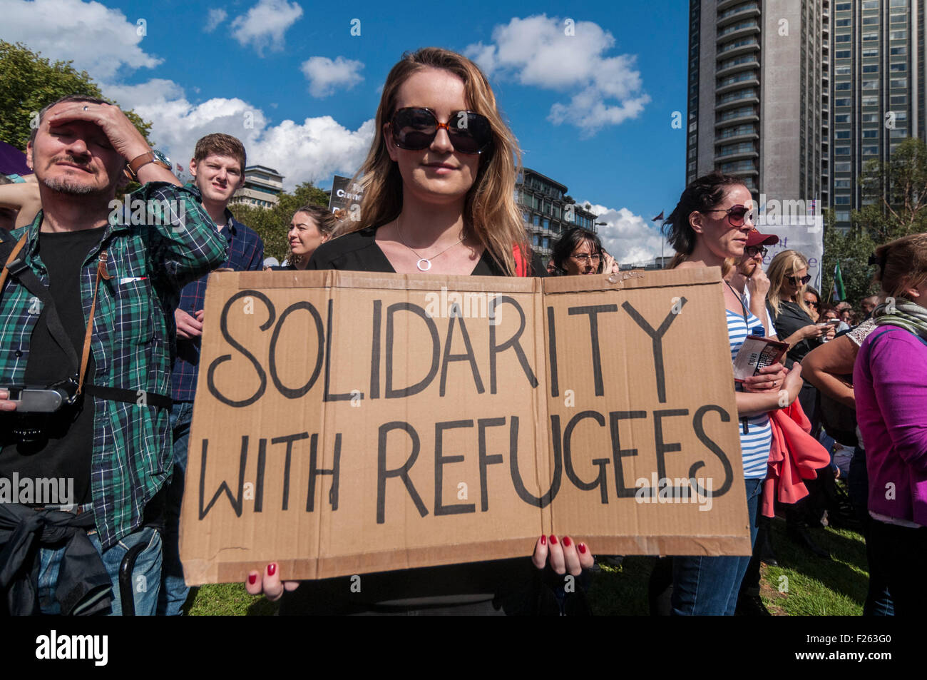 London, UK. 12 September 2015. A girl with a banner as tens of ...