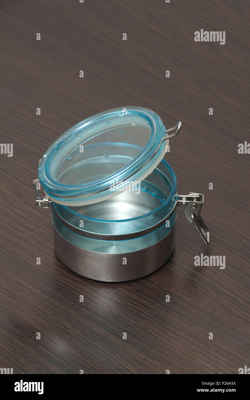empty metallic food container with blue glass cap Stock Photo - Alamy