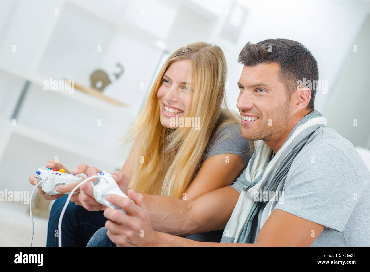 Competitive couple playing video games at home Stock Photo - Alamy