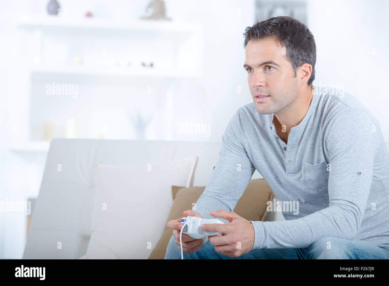 Man playing video games alone Stock Photo - Alamy