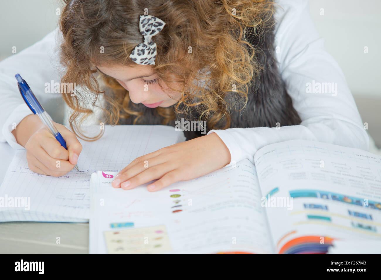 Little girl doing her homework Stock Photo - Alamy