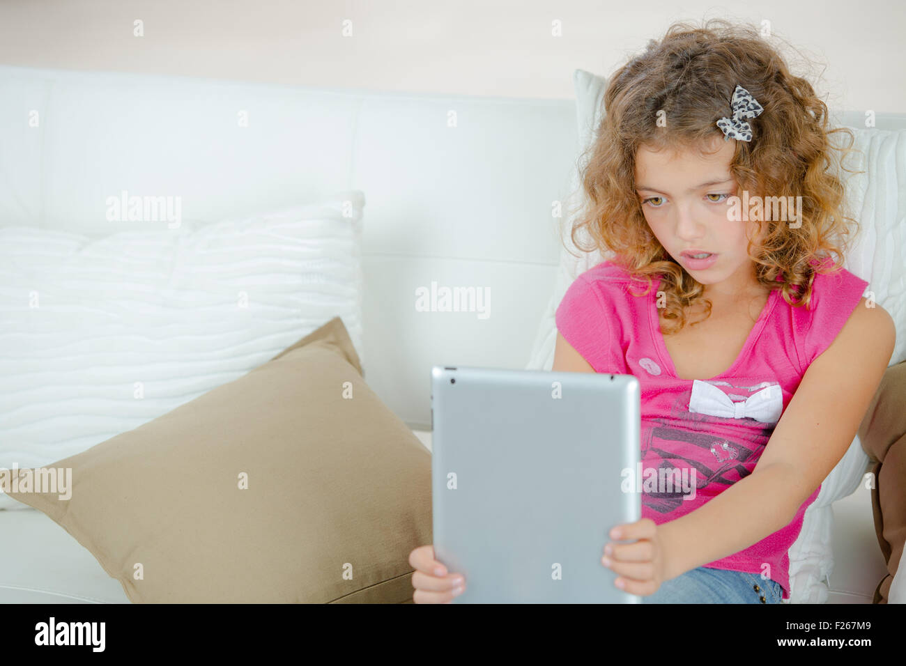 Girl looking at tablet Stock Photo - Alamy