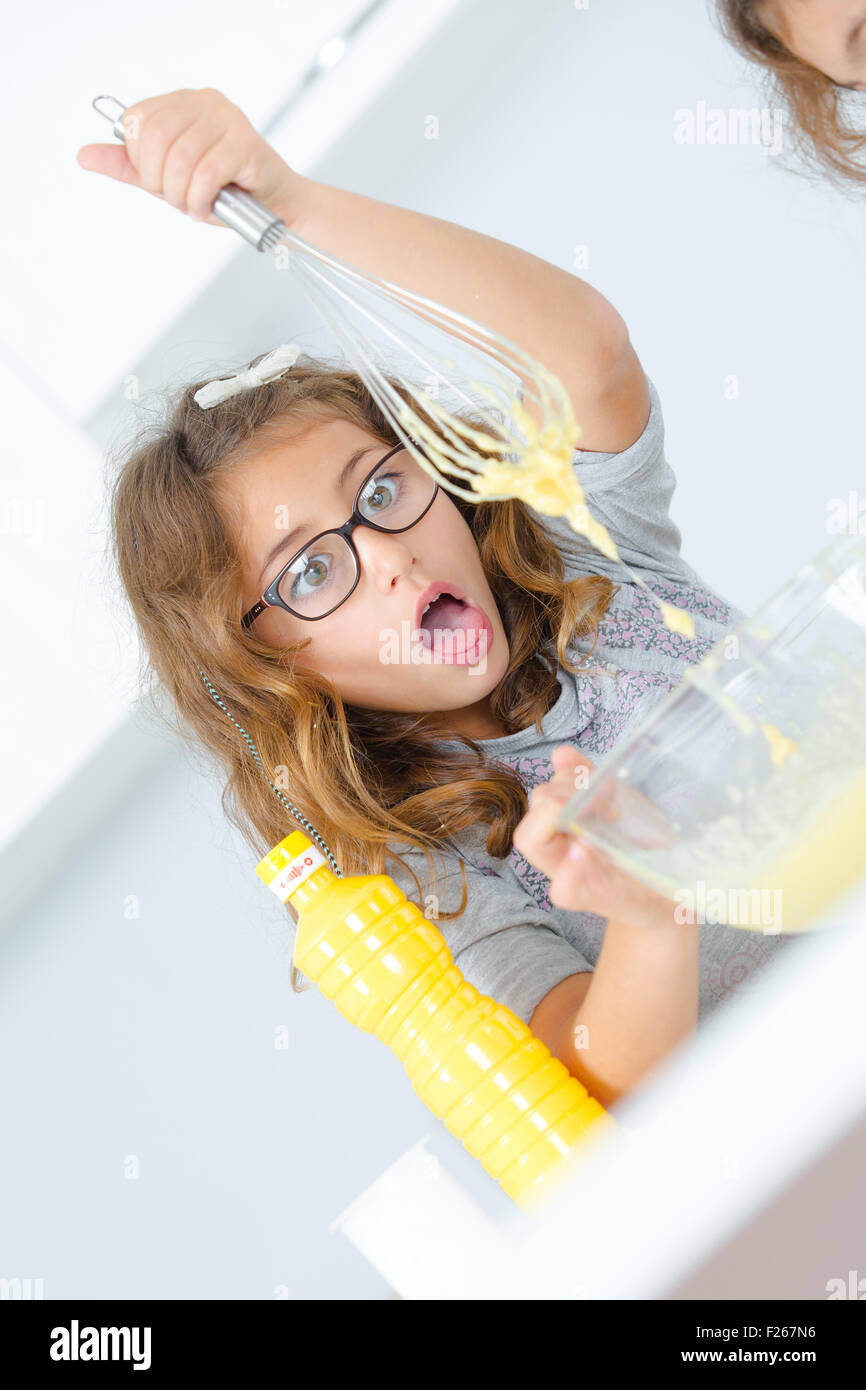 Kid making a cake all alone Stock Photo - Alamy