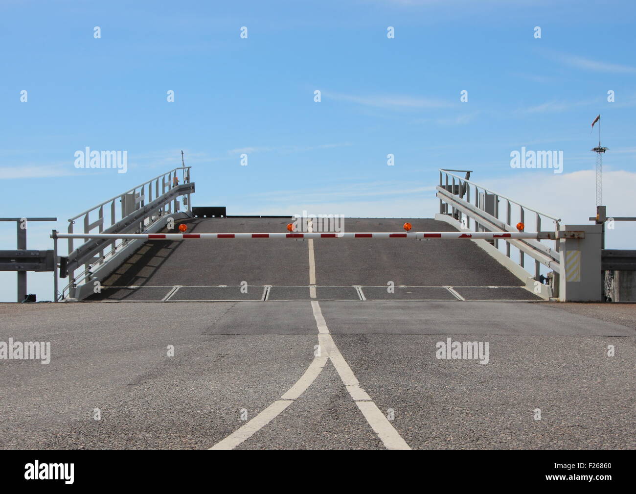 Empty Ferry Ramp Road with Closed Safety Boom and Blue Sky Stock Photo ...