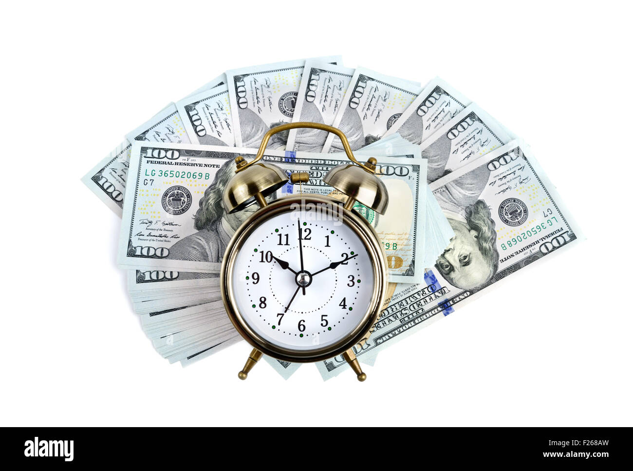 Alarm clock on money background Stock Photo - Alamy
