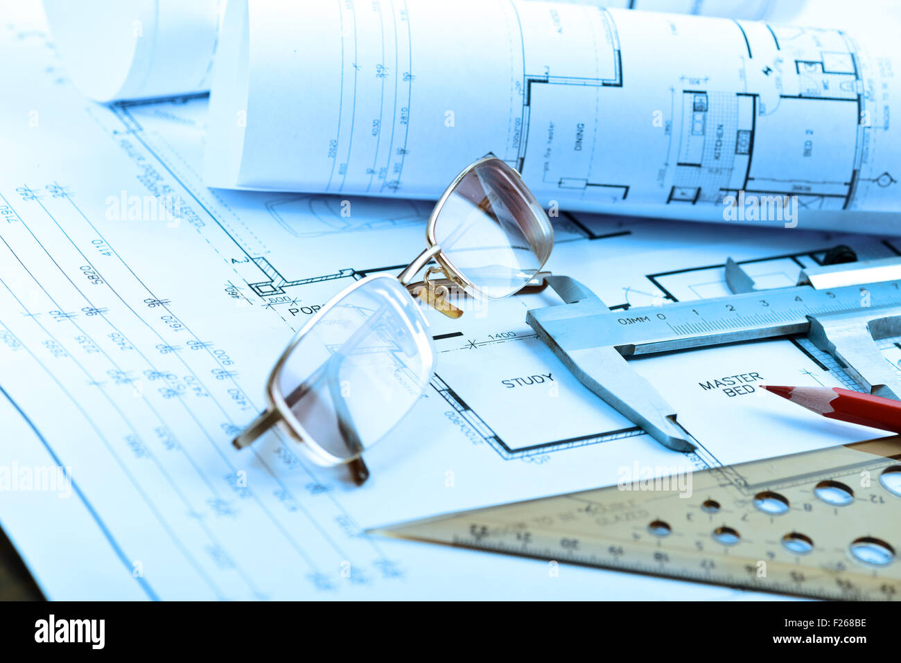 Architectural blueprints rolls and engineering items. Toned in blue ...