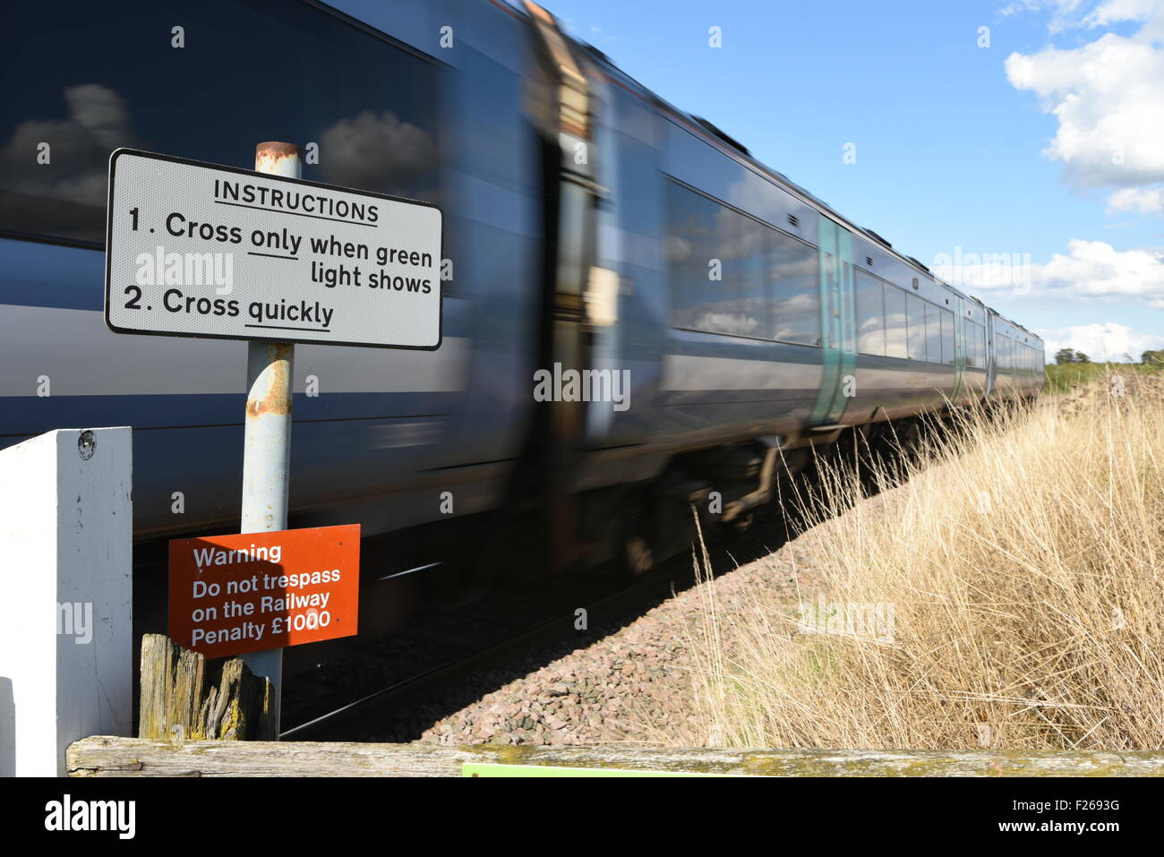 Train passing crossing Stock Photo - Alamy