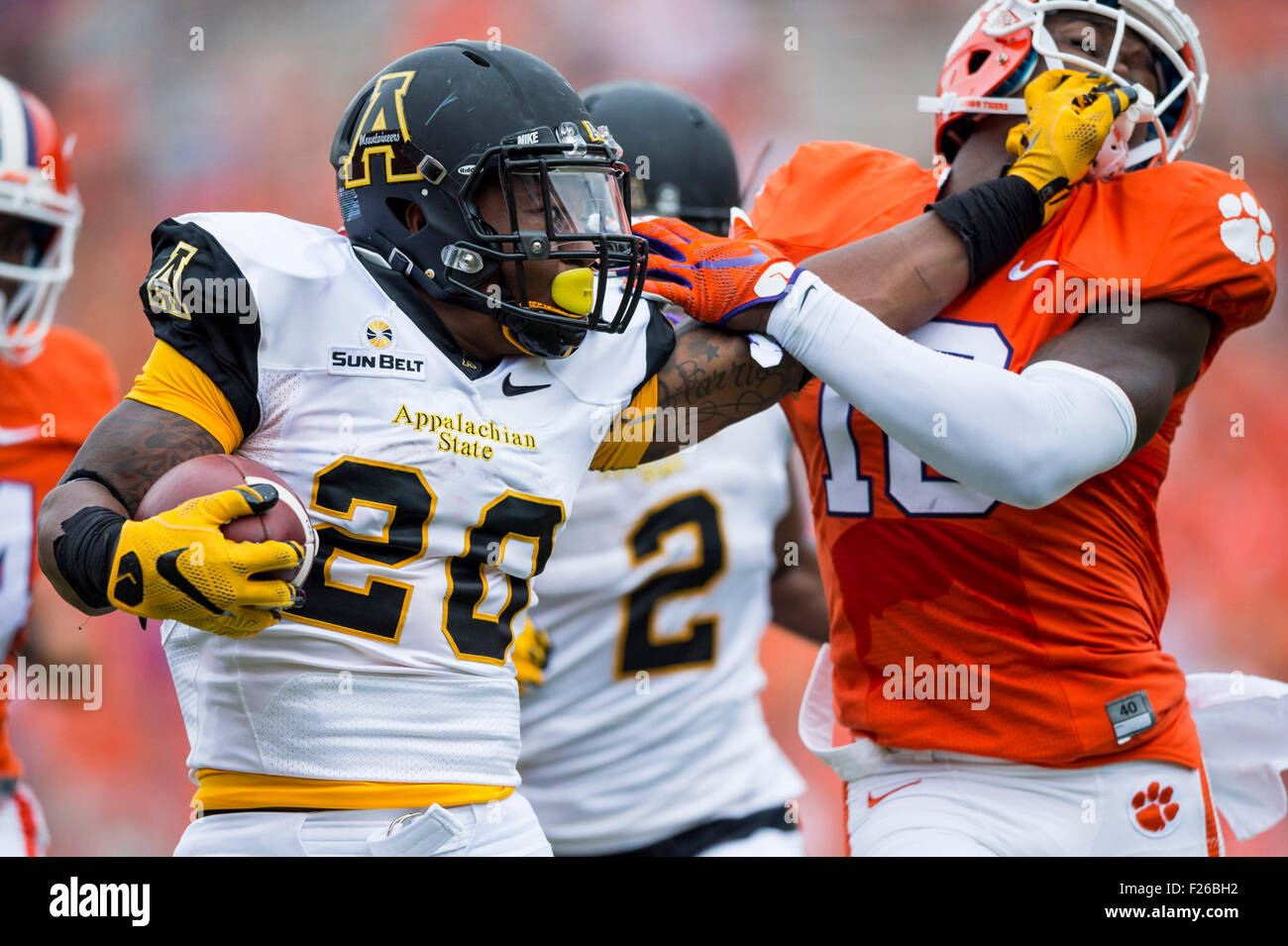 App State running back Terrence Upshaw (20) stiff arms Clemson safety ...
