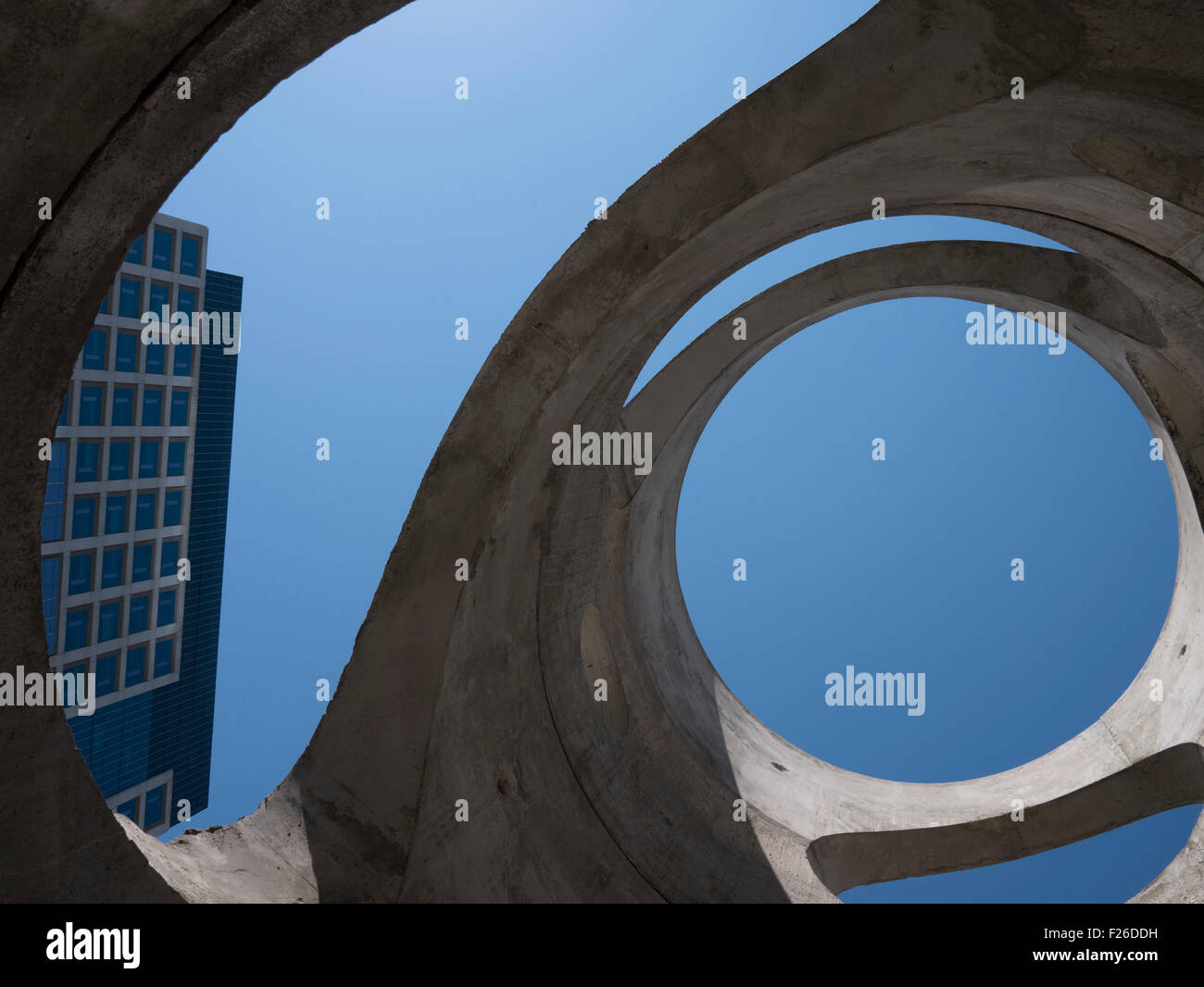 Low angle view of corporate skyscraper through art installation at ...