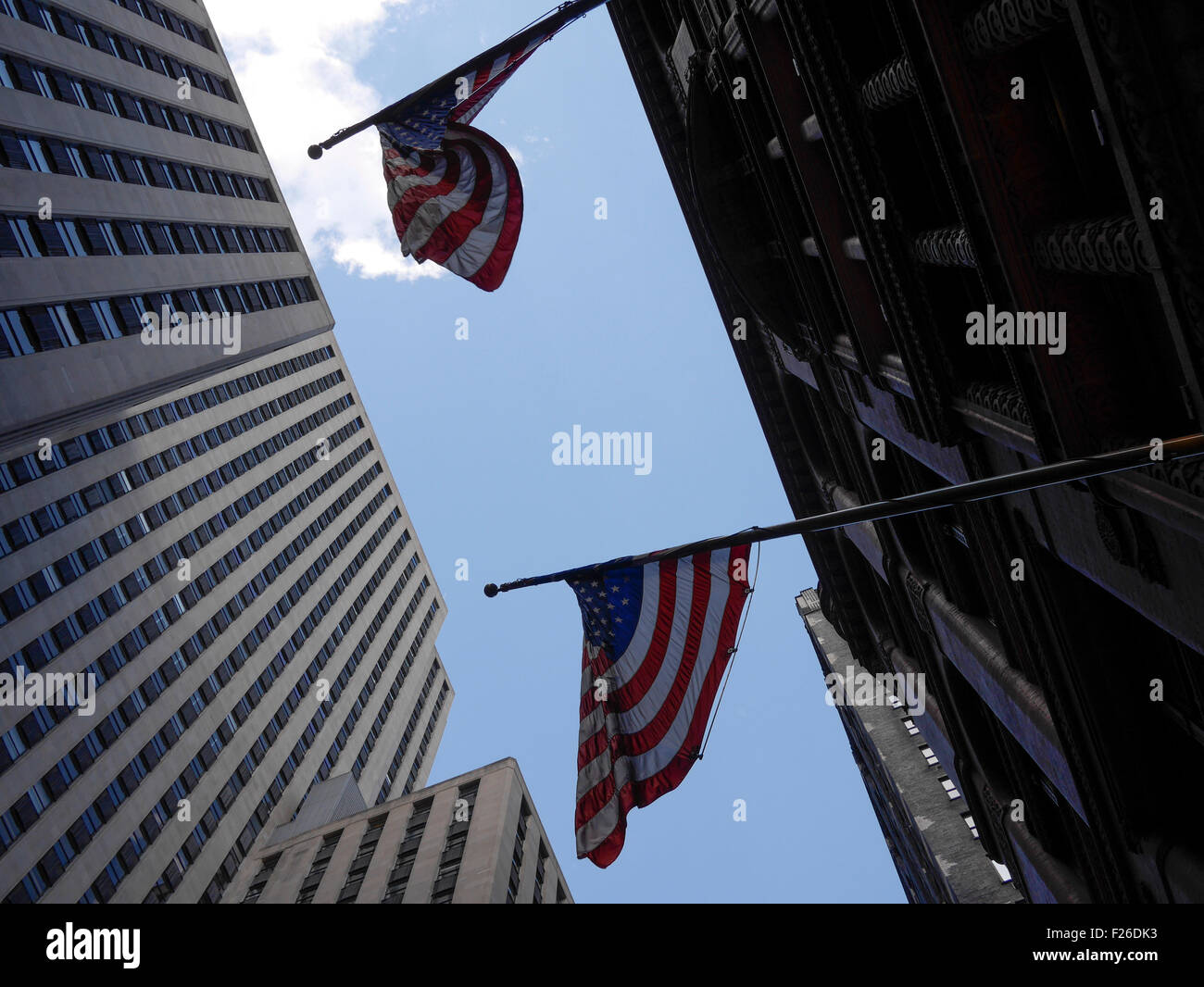 Low angle view of corporate skyscraper displaying American flag Stock ...