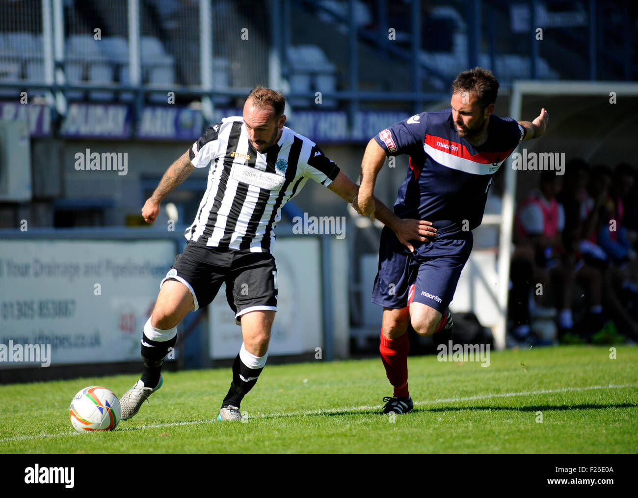 Dorchester, England. 12th September 2015. Ben Watson DTFC (left) takes ...