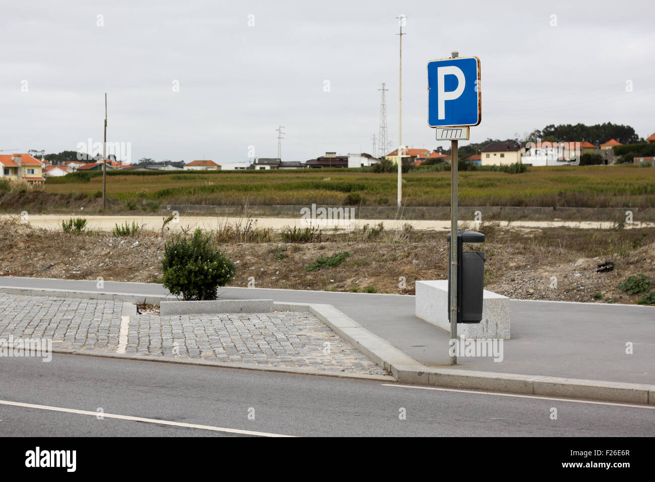 Open air free parking place with a blue parking sign Stock Photo - Alamy