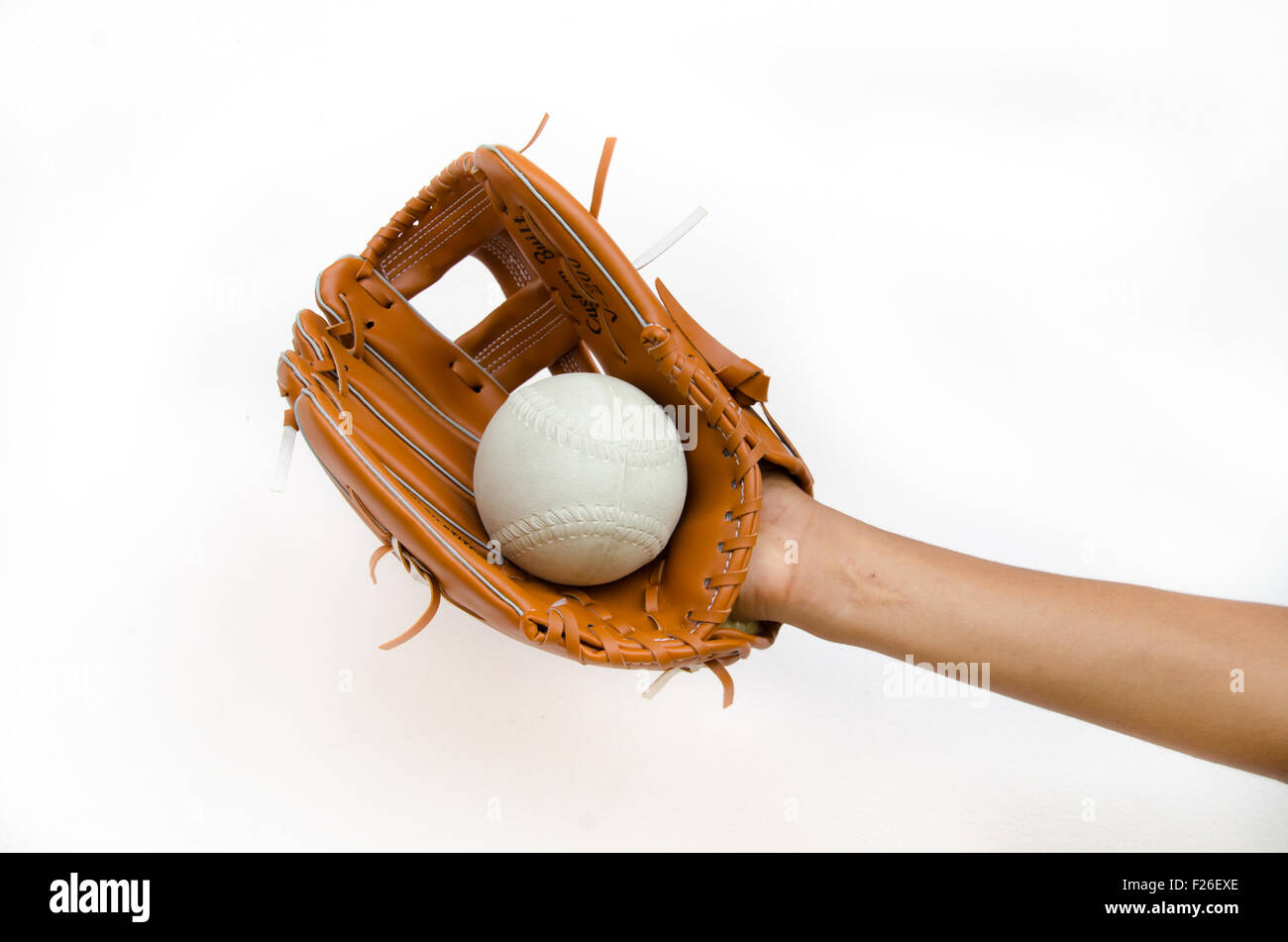 hand of children catching the ball with leather glove on white ...