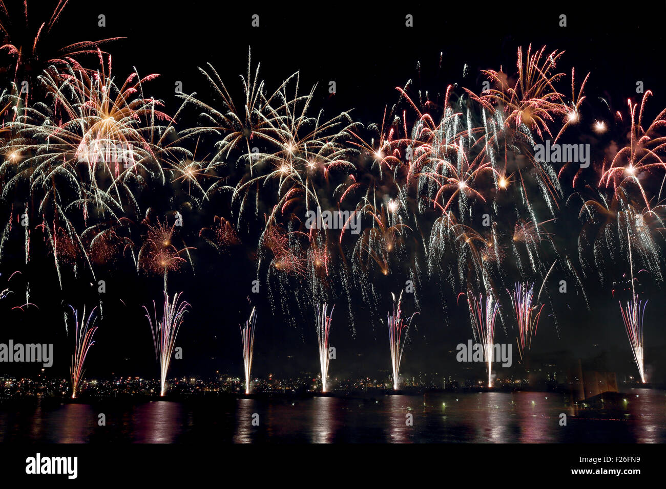 colorful fireworks reflect on sea water Stock Photo - Alamy