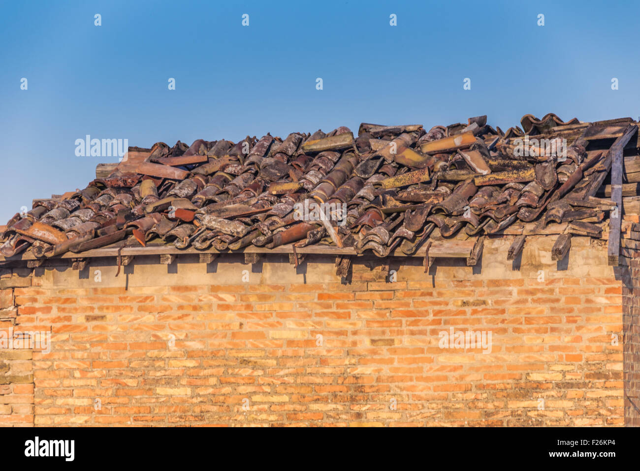 roof in disrepair with drooping broken tiles of abandoned country house ...
